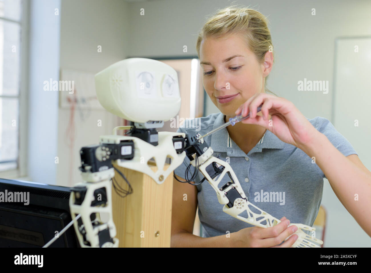 a woman fixing a robotic arm Stock Photo - Alamy