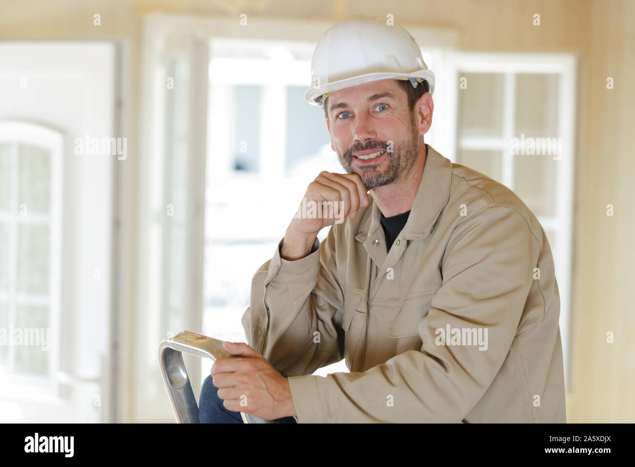 construction worker looking at the camera Stock Photo - Alamy