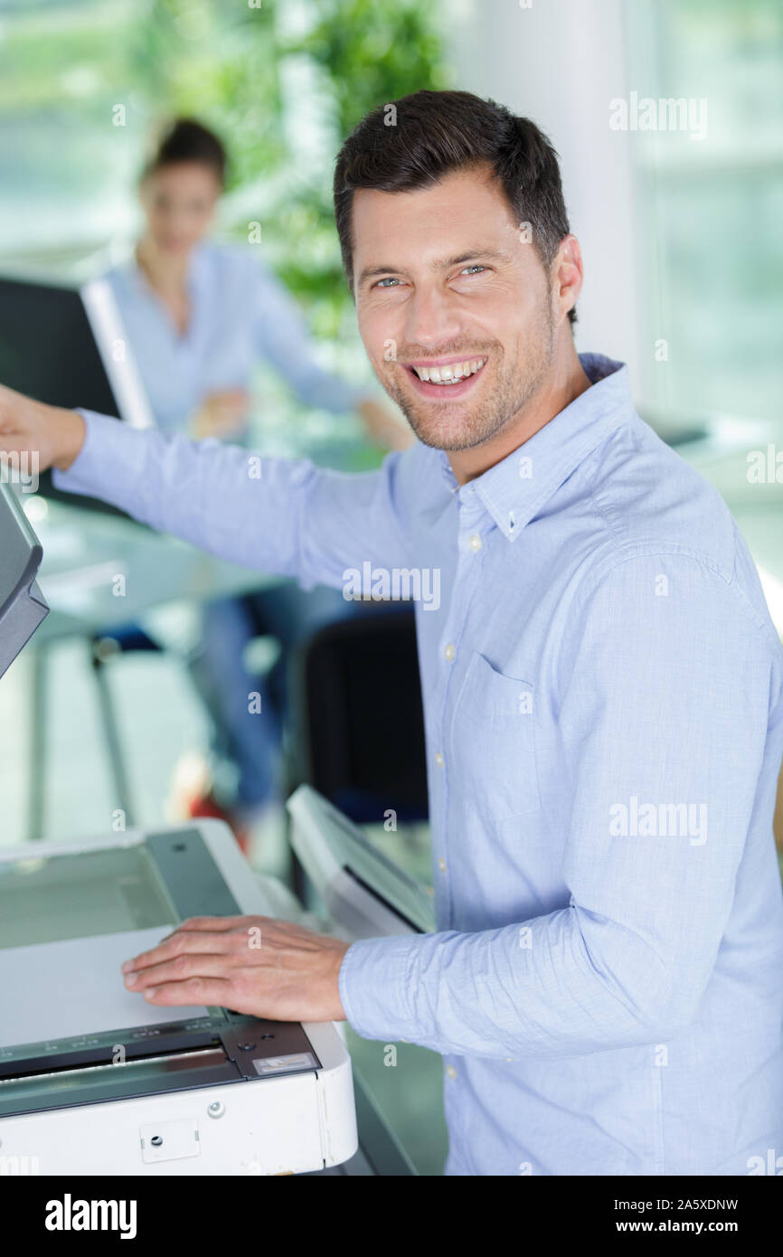 happy man using a copy machine Stock Photo - Alamy