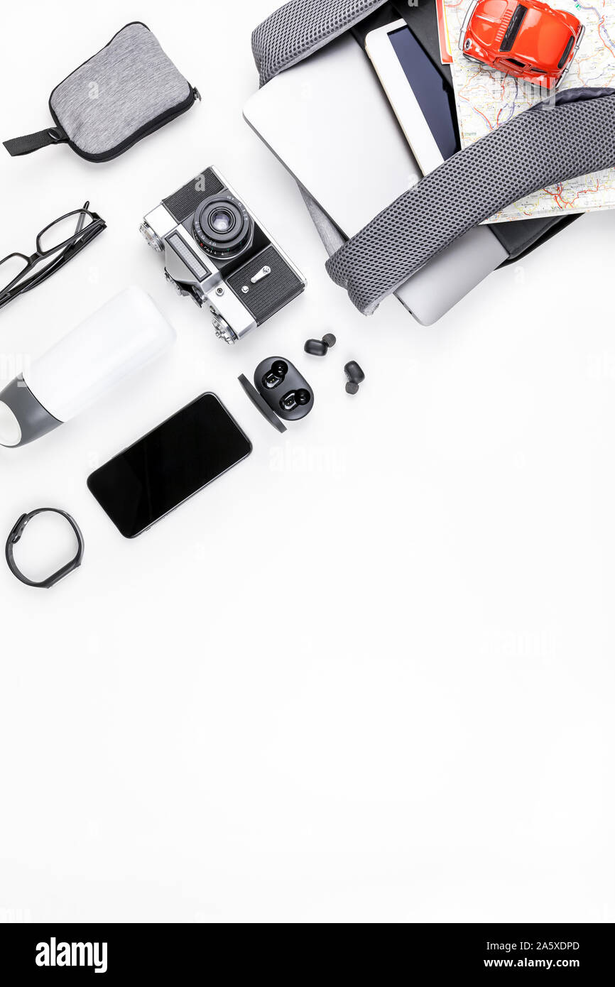 Creative top view flat lay of open backpack with laptop and tablet ...