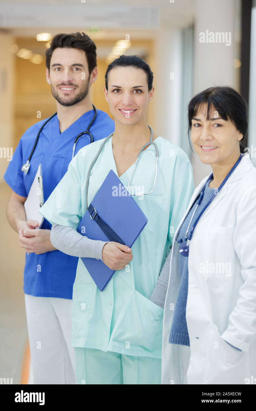 portrait of three medical workers stood in a row Stock Photo - Alamy