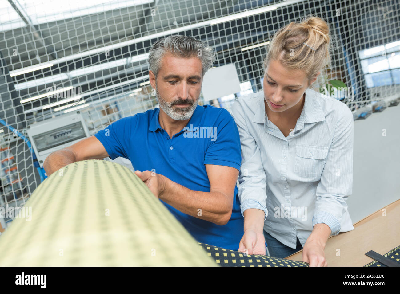 two workers working in fabric factory Stock Photo - Alamy