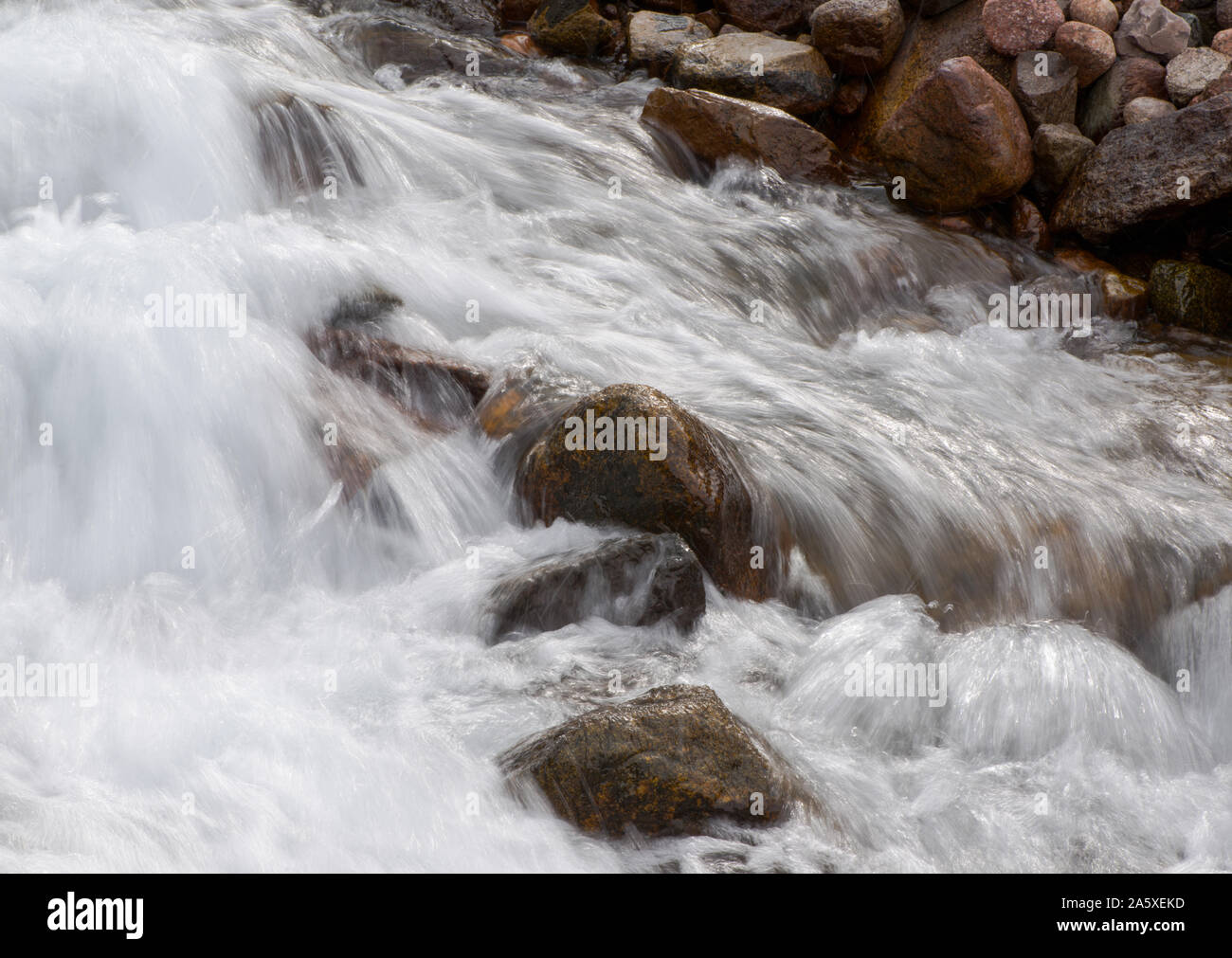 the flow of a mountain river with rounded stones Stock Photo - Alamy