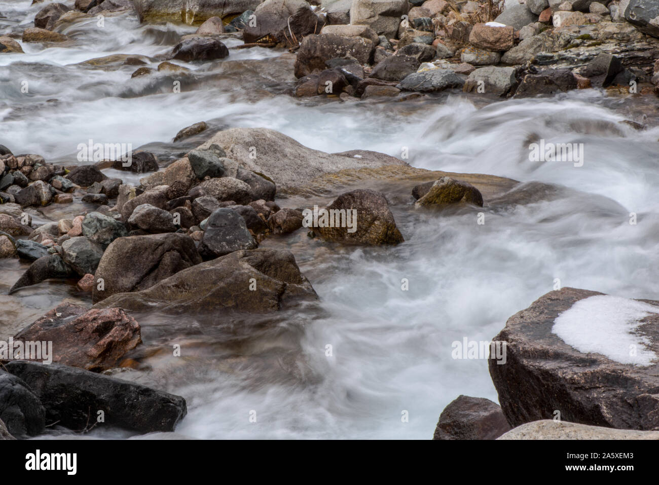 the flow of a mountain river with rounded stones Stock Photo - Alamy