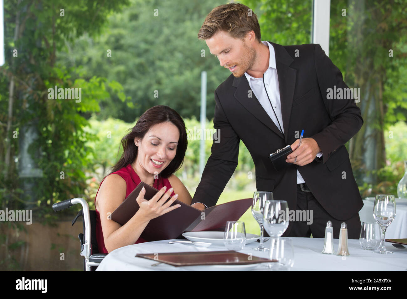 waiter giving suggestion to the customer Stock Photo - Alamy