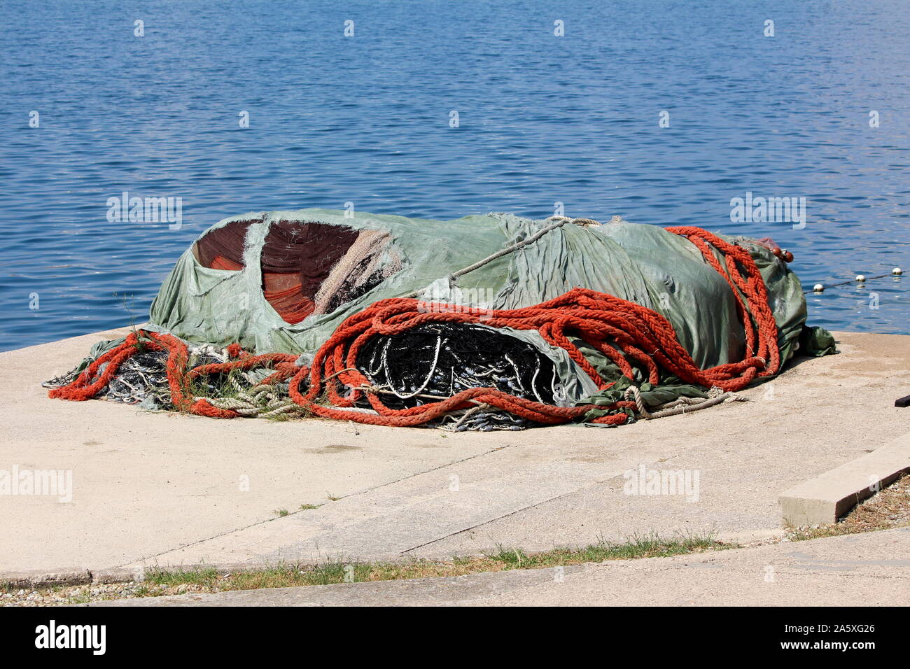 Large pile of heavily used fishing nets covered with nylon protection ...