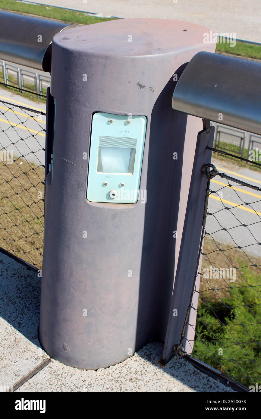 Modern LED light on side of thick stone column surrounded with metal ...