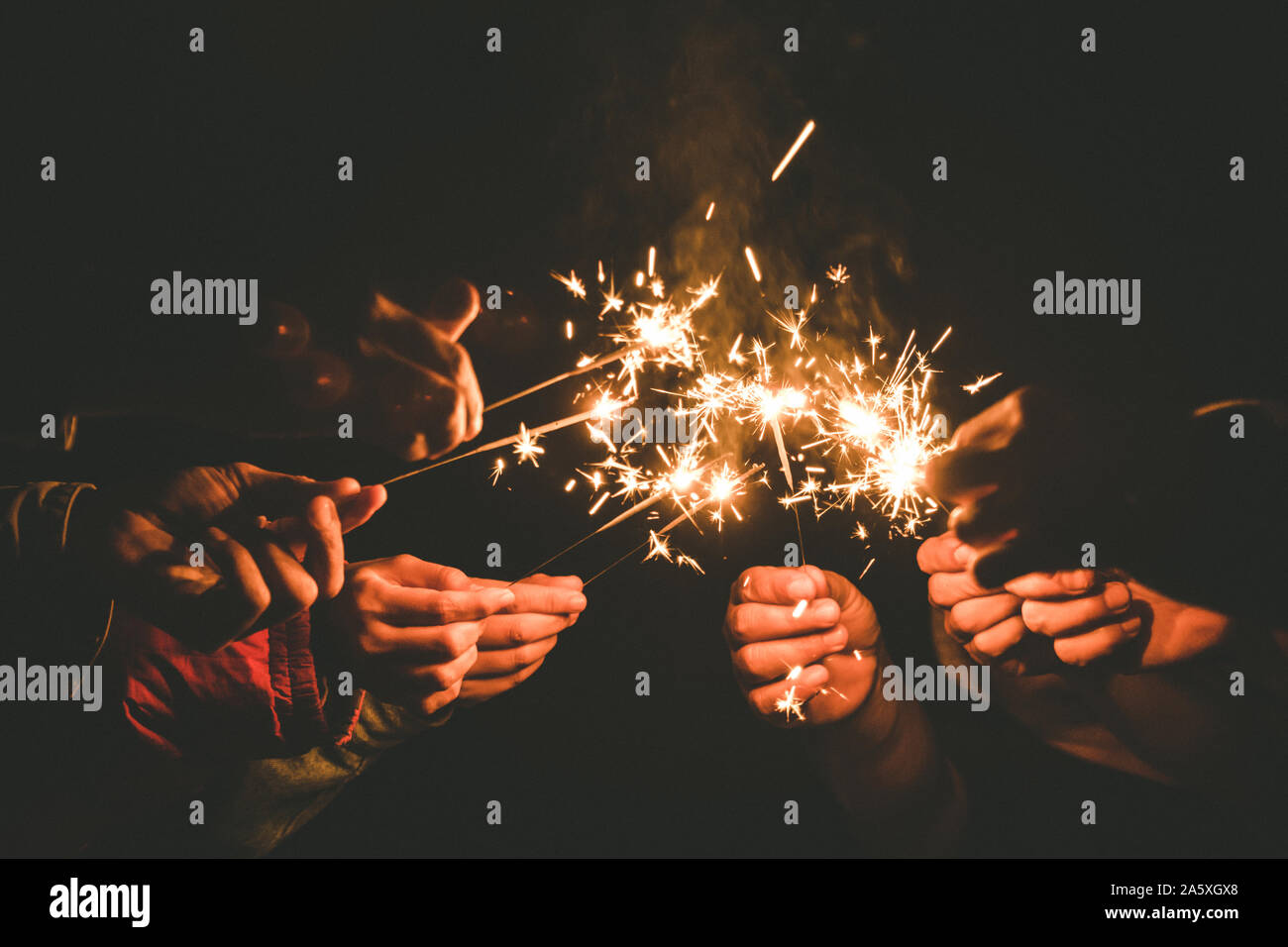 Closeup image of hands holding sparklers for celebrate in the night ...