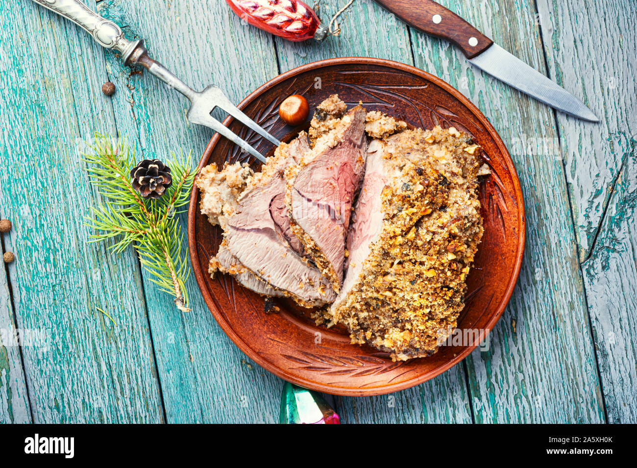 Baked meat under a bread crust with nuts Stock Photo - Alamy