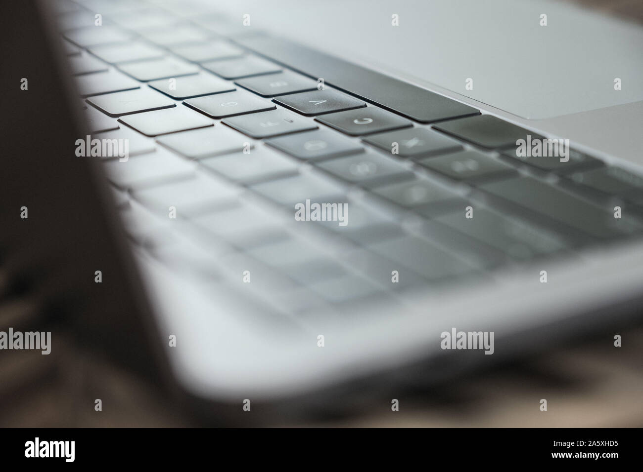 Closeup image of a laptop keyboard with blur background Stock Photo - Alamy
