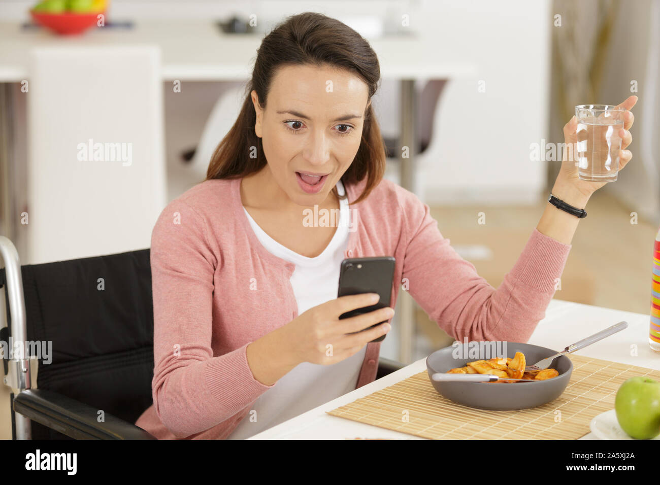 woman with shocked expression reading text message Stock Photo - Alamy