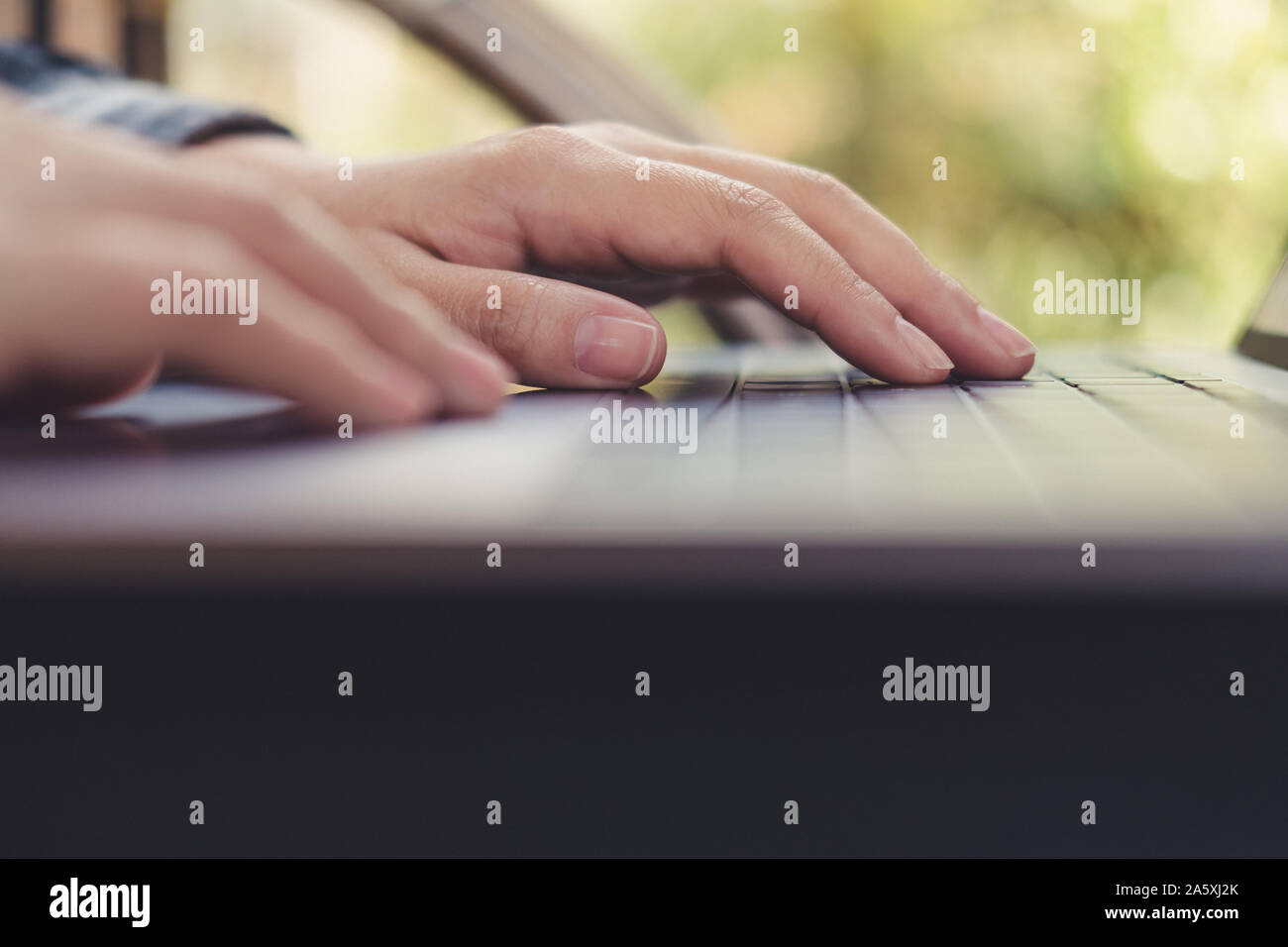 Closeup image of hands working , touching and typing on laptop keyboard ...