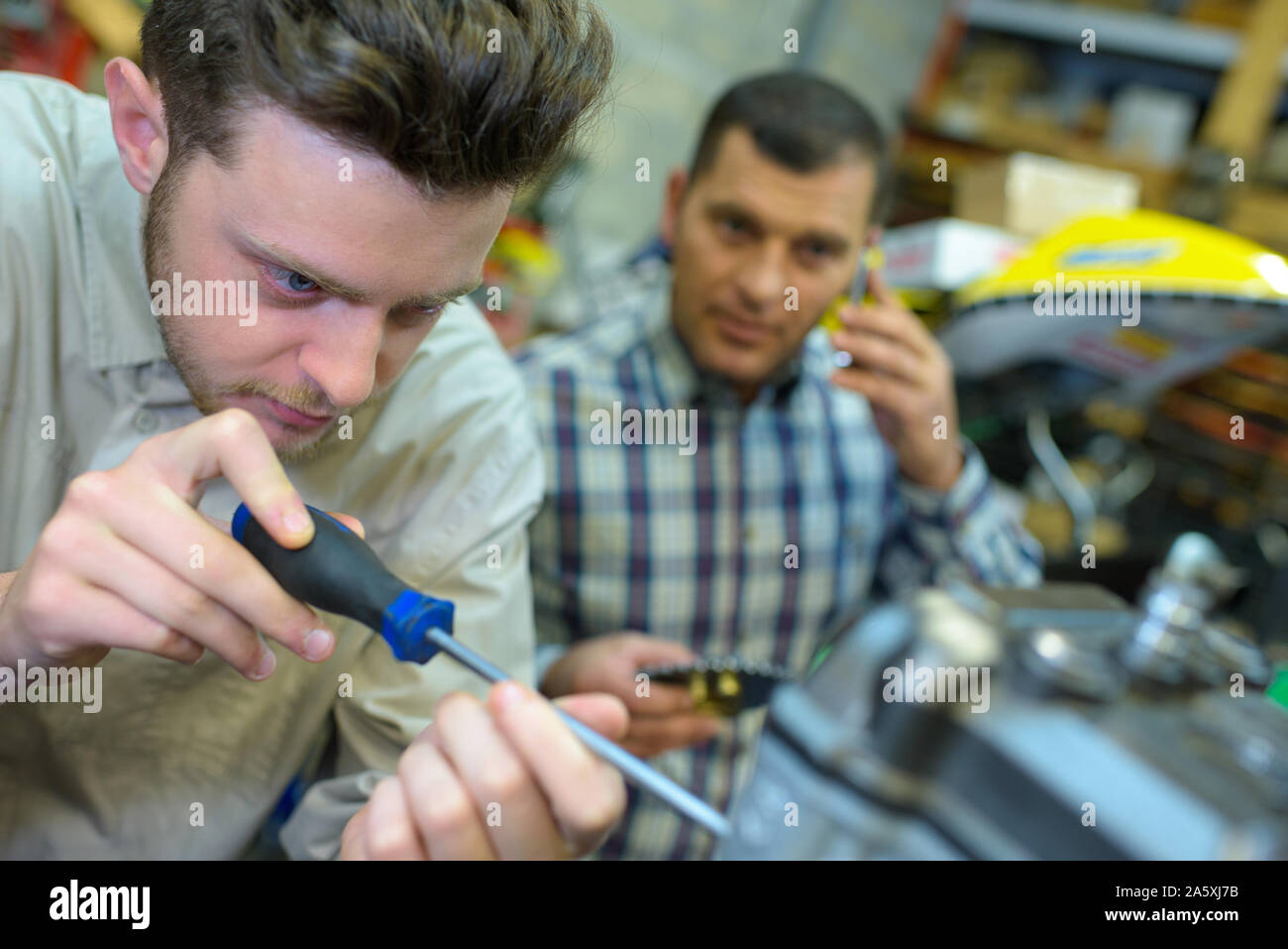 male machinist working on machine part Stock Photo - Alamy