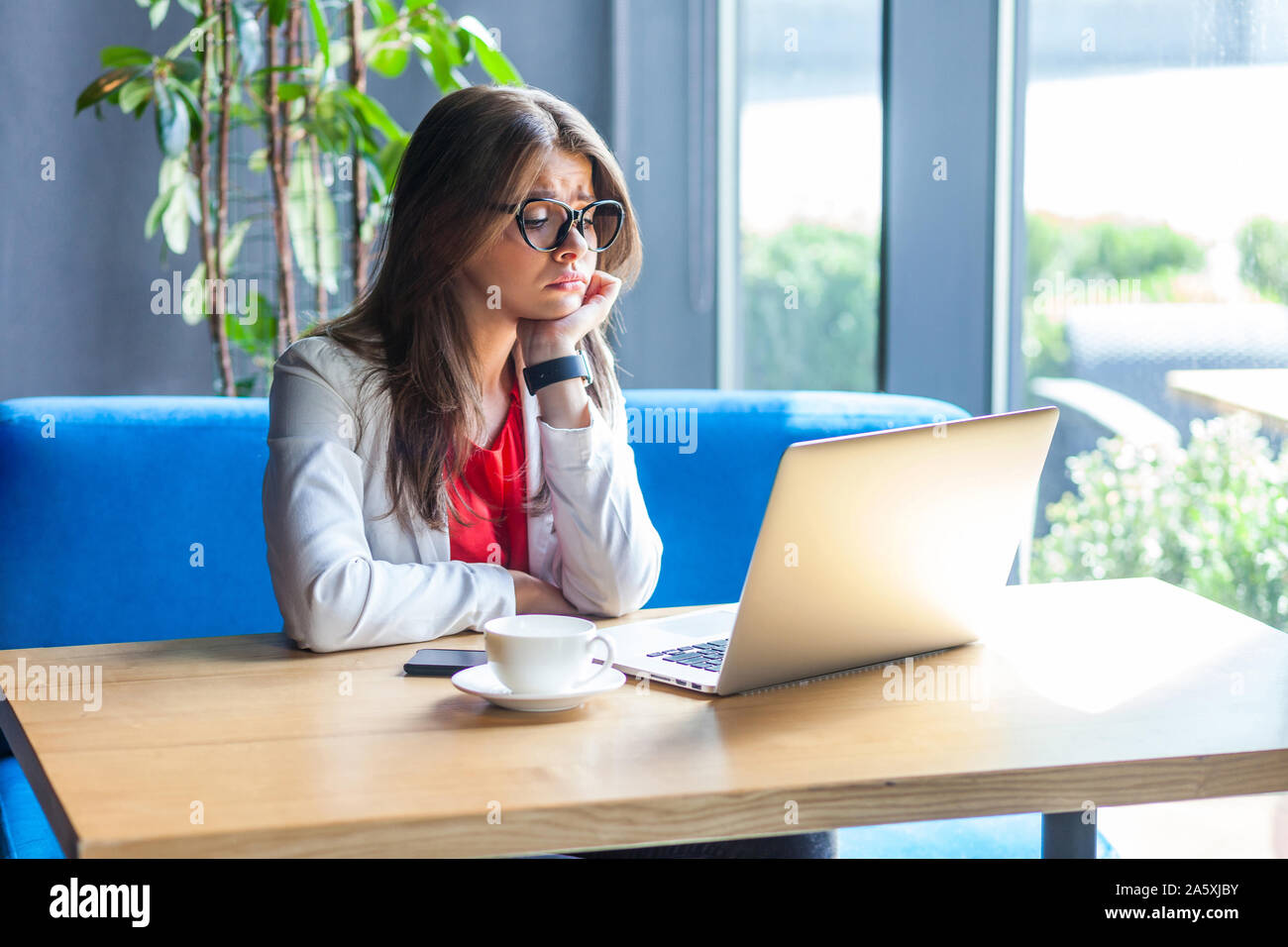 Portrait of sad alone beautiful stylish brunette young woman in glasses ...