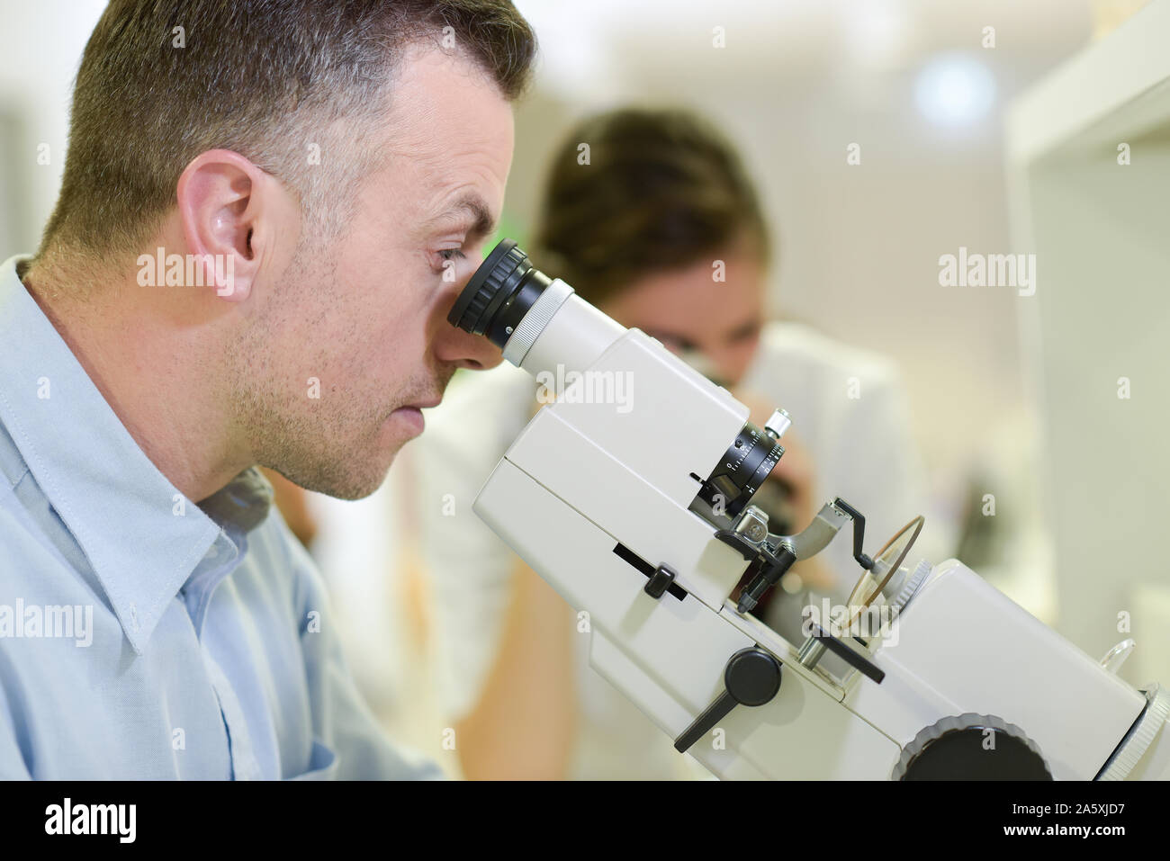 man with microscope in lab at university Stock Photo - Alamy