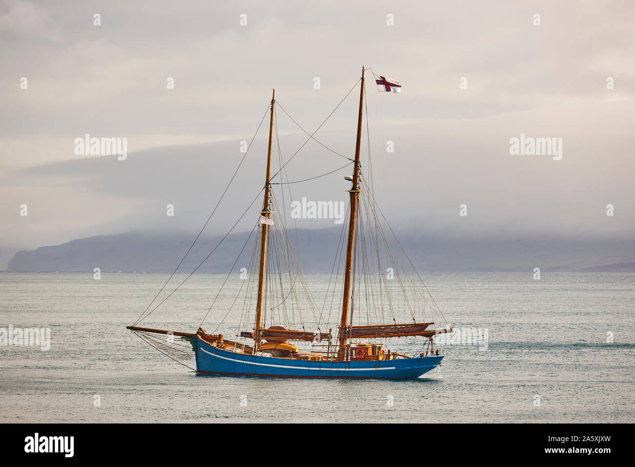 Yacht sailing on Faroe island fjords. Atlantic ocean coastline ...