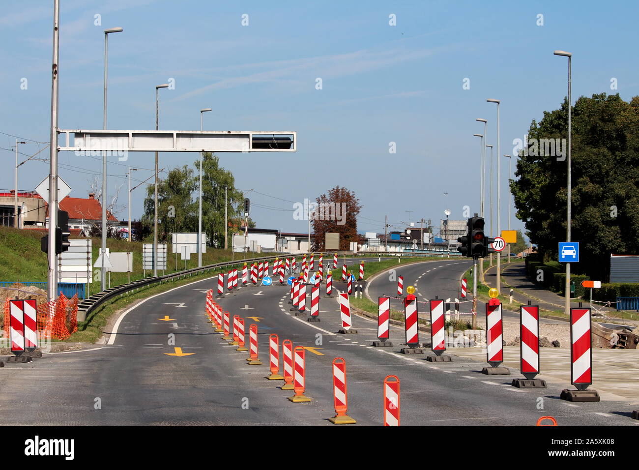 Rows of warning road signs with signal lights separating temporary ...