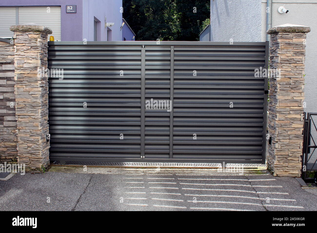 Strong tall dark grey metal family house driveway doors with ...