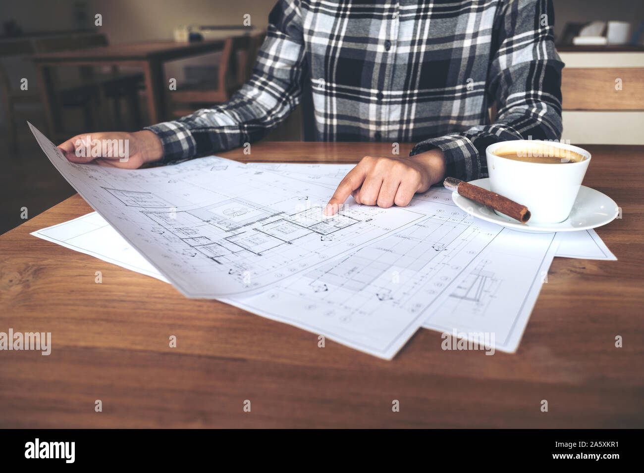 An architect working and pointing at shop drawing paper on table Stock ...