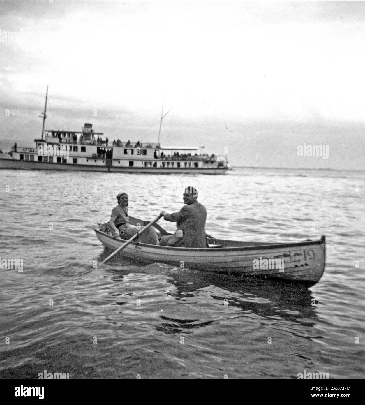 Two people in rowing boat Black and White Stock Photos & Images - Alamy