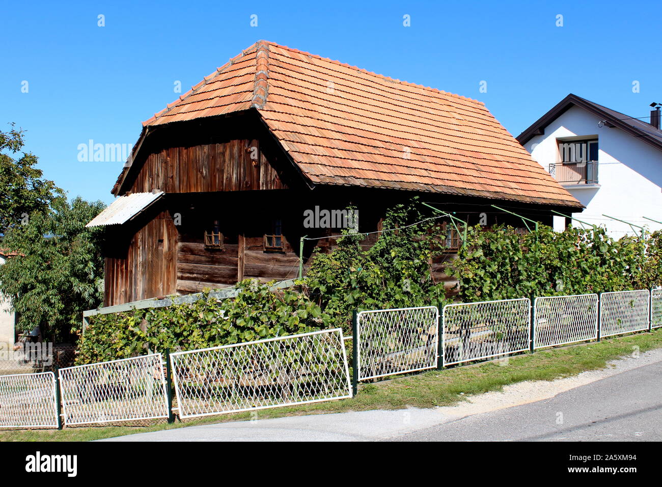 Very old vintage wooden boards suburban family house with red roof tiles and dilapidated windows ...