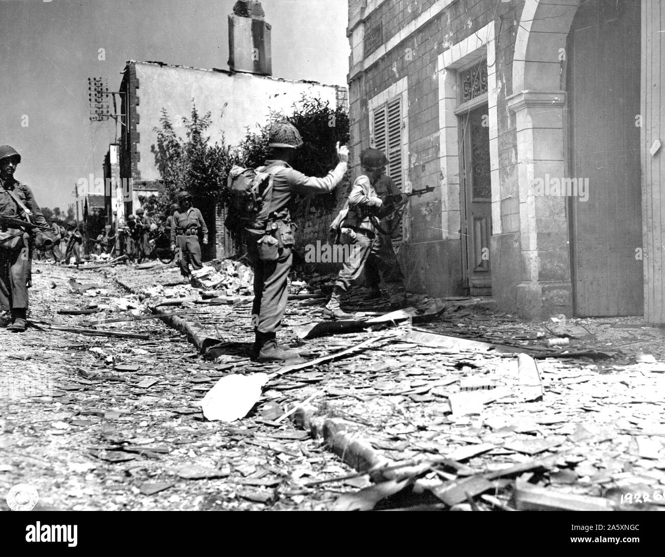 Original caption: As two infantrymen station themselves near the door ...
