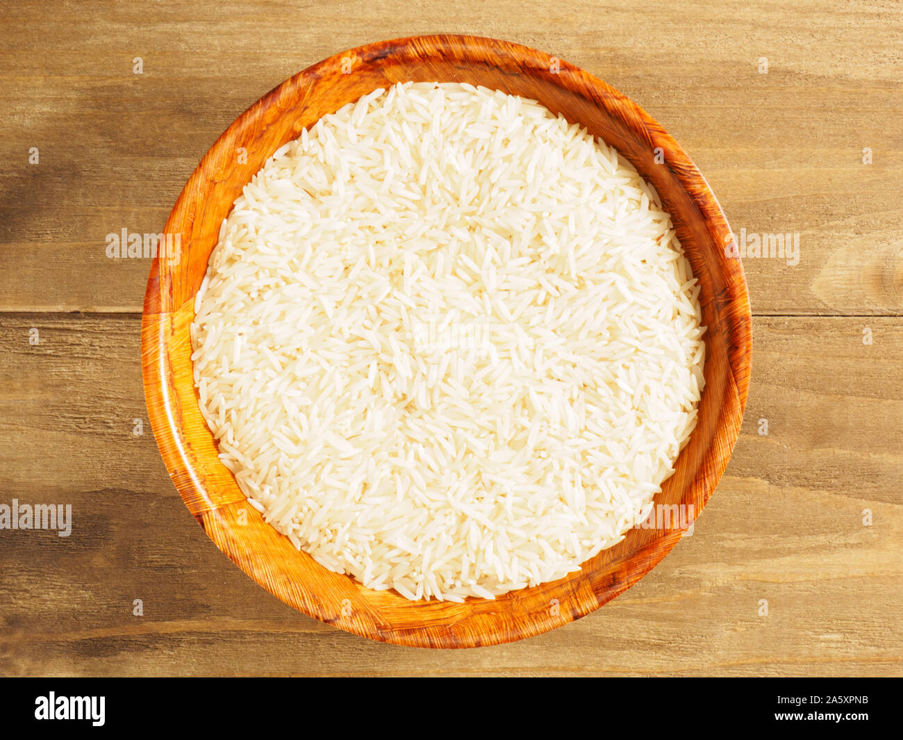 Rice in bamboo bowl on brown wooden background. Indian cuisine ...
