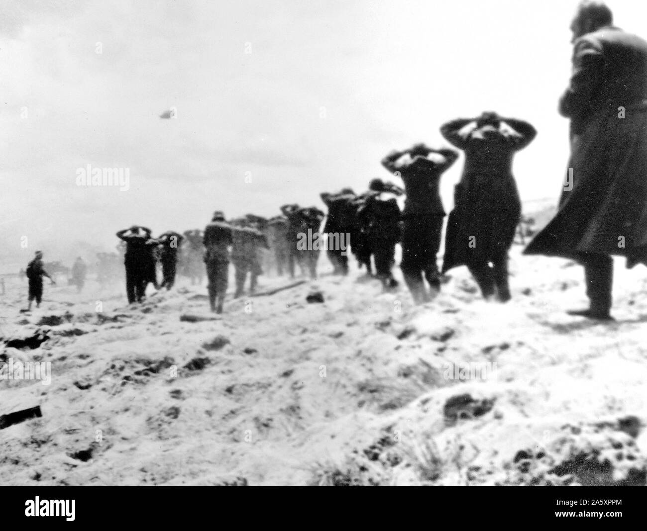 [ORIGINAL CAPTION:] THE LONG ROAD BACK...These Germans, until a few moments ago, members of ...