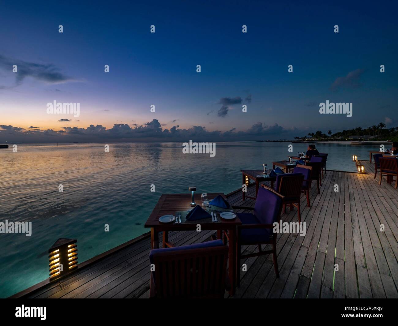 Sunset on the beach with restaurant on Maldives island South Male Atoll ...