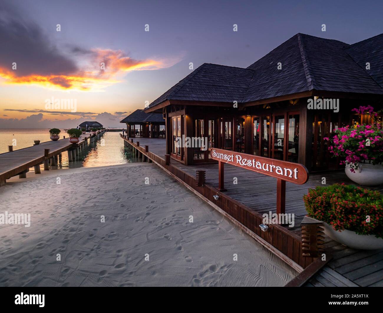 Sunset on the beach with restaurant on Maldives island South Male Atoll ...