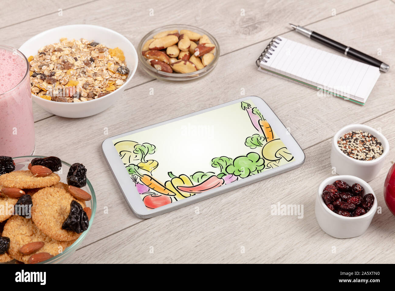 Healthy food composition with tablet Stock Photo - Alamy