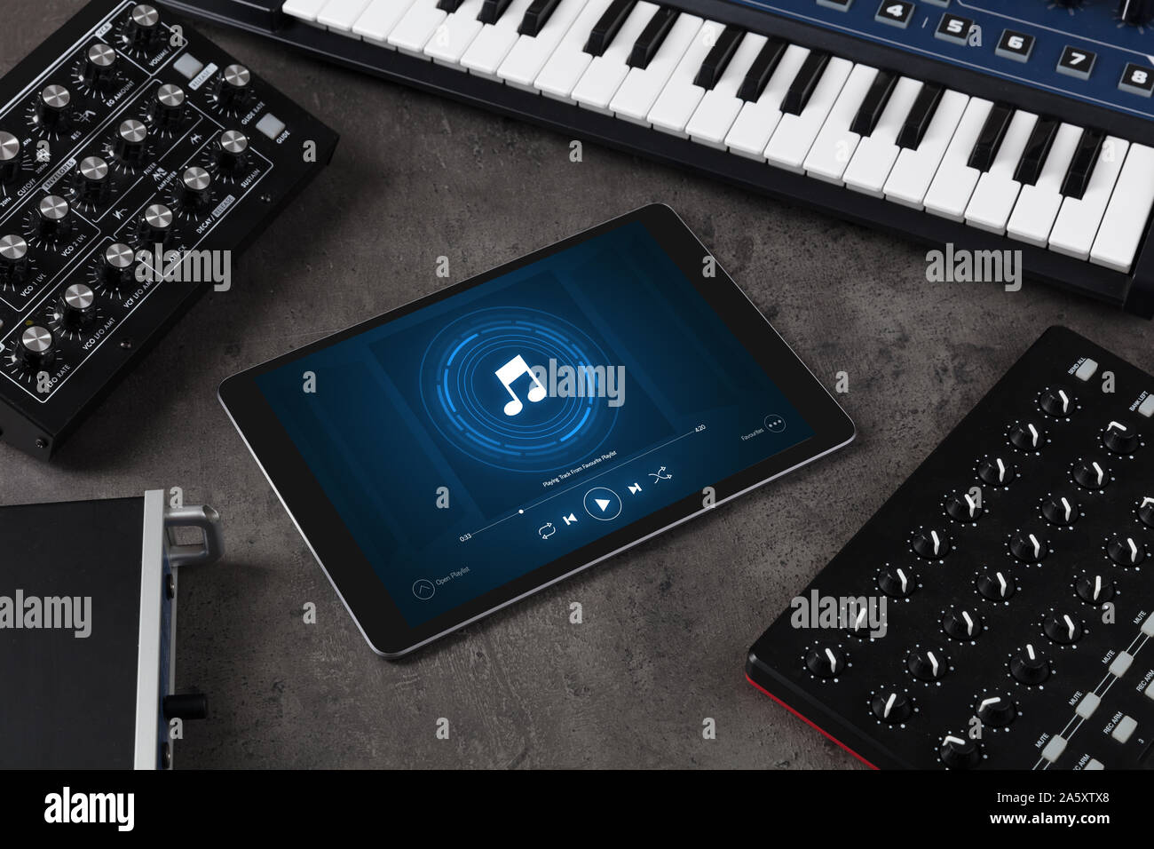Playing song on tablet with electronic music instruments around Stock ...