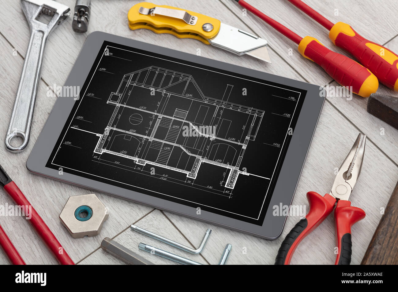 Tablet with construction tools and blueprint concept Stock Photo - Alamy