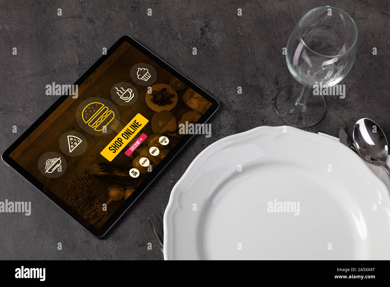 Online fast food order concept on a laid table Stock Photo - Alamy