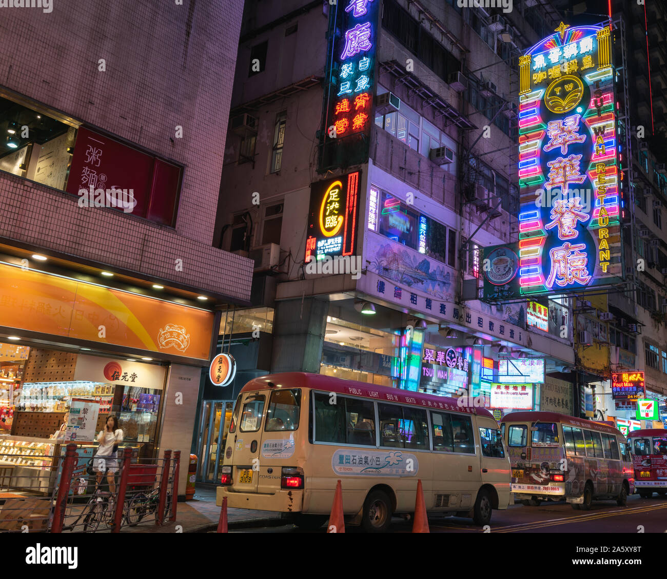 Vibrant neon signs and bright streetlights glowing above the busy night ...