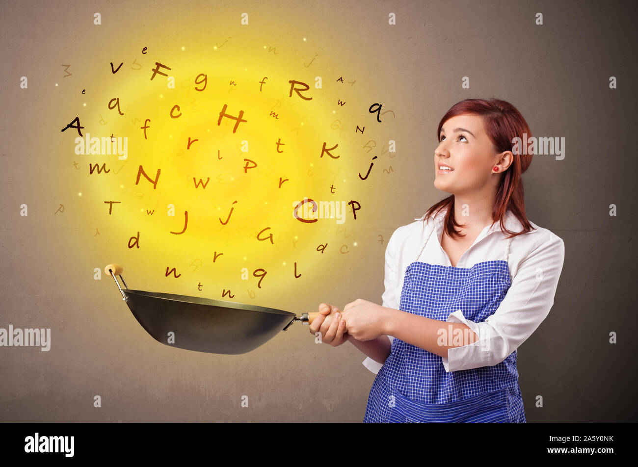 Young person cooking letters in wok Stock Photo - Alamy