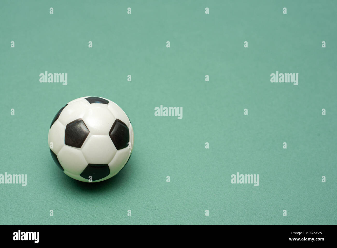 Football ball on a green field flat lay background with copy space ...