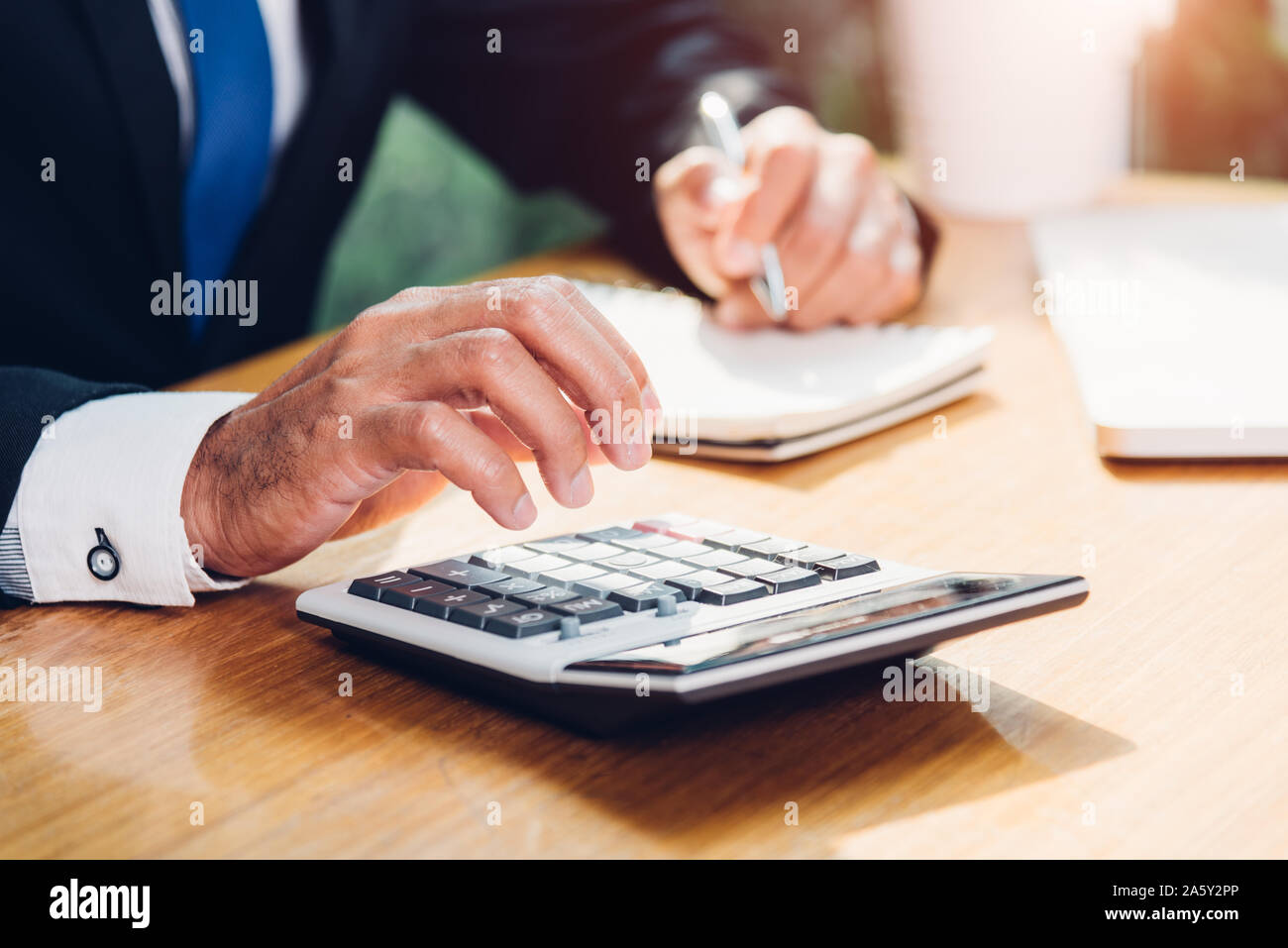 Business man accounting using calculating and work with laptop computer ...
