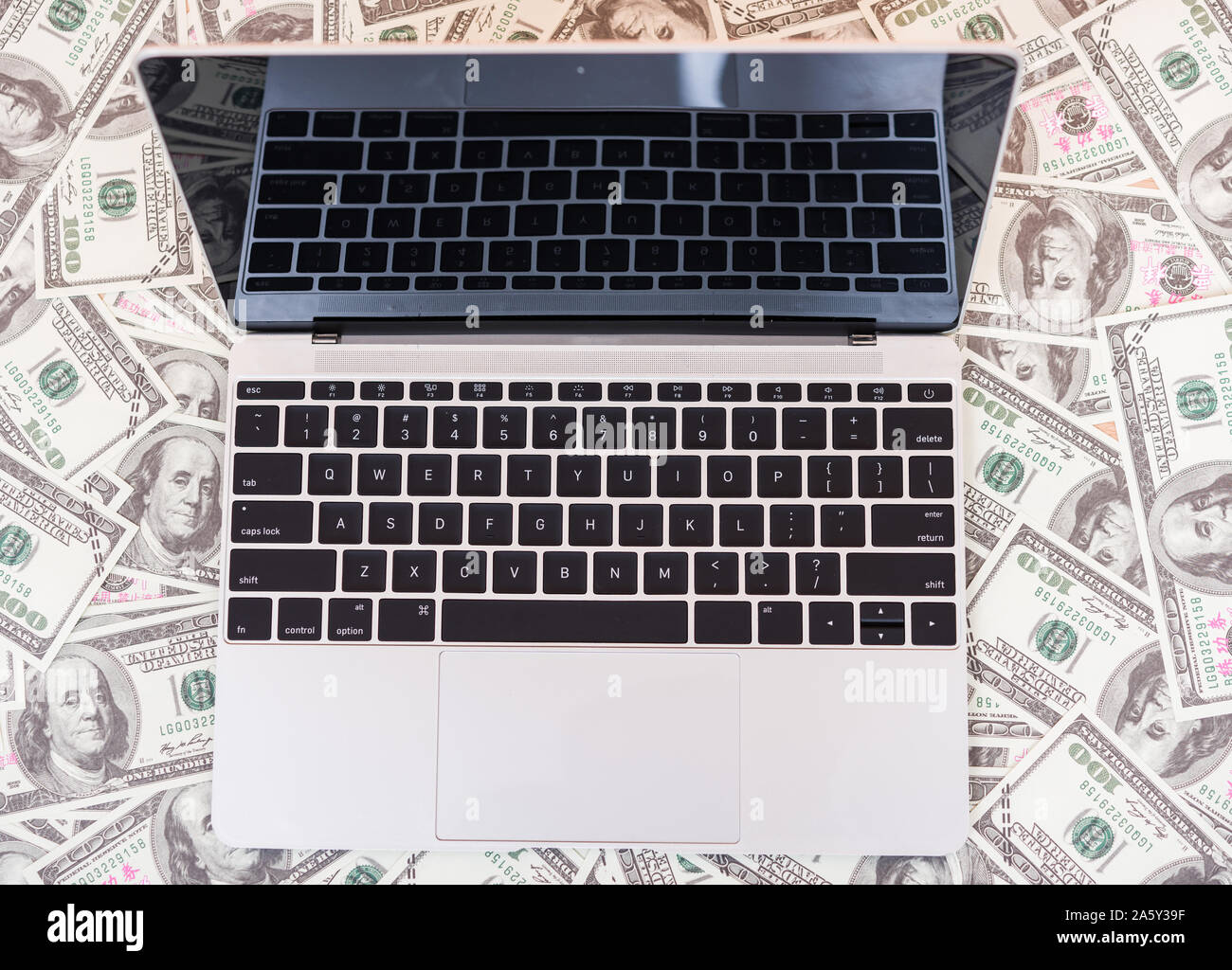 Top view of laptop computer on dollar money, finance investment ...