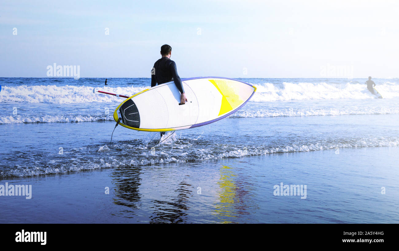 Guy standing in the water on a beach hi-res stock photography and ...
