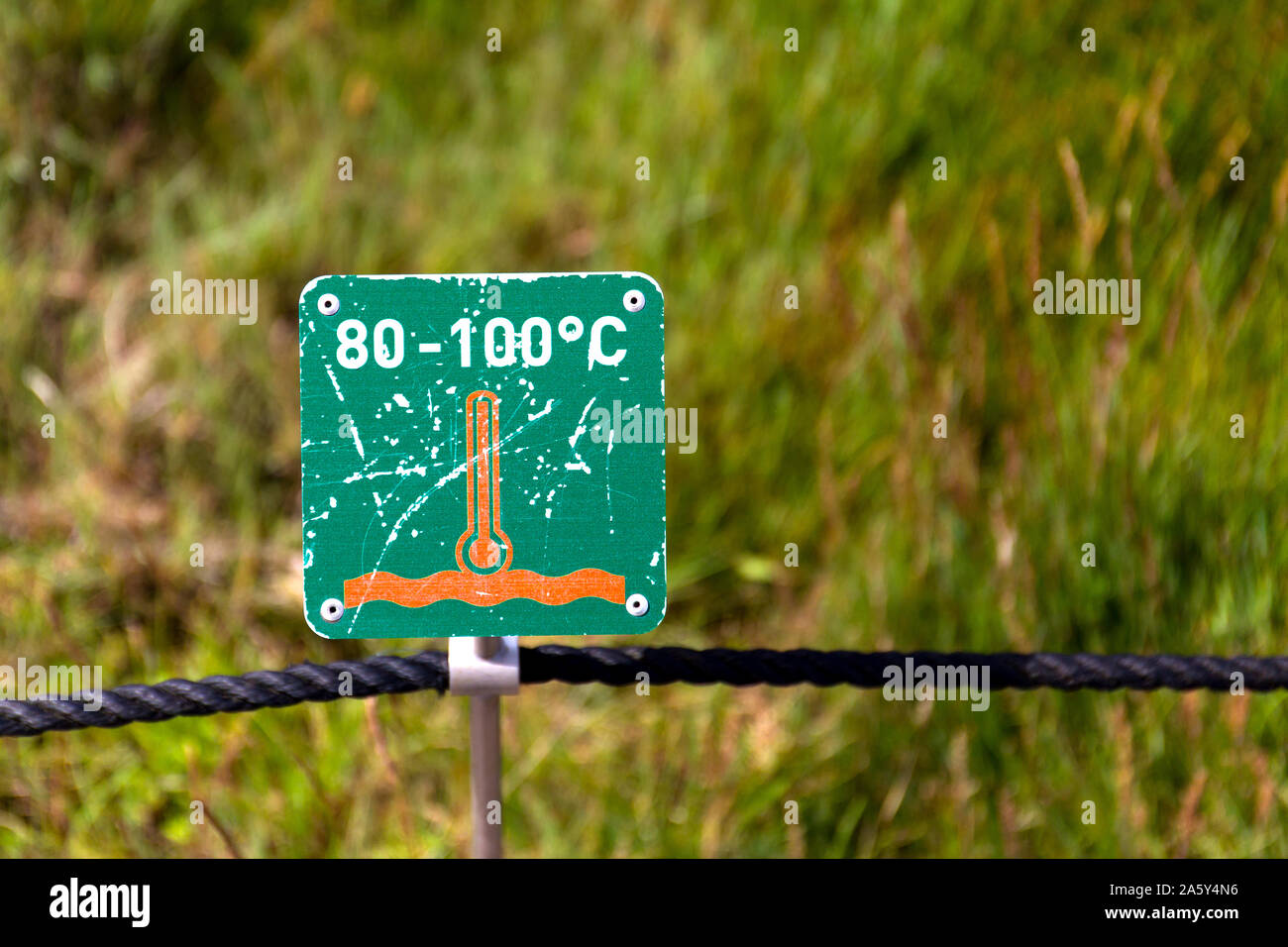 Warning sign of hot earth. Caution of high temperatures. The golden ...