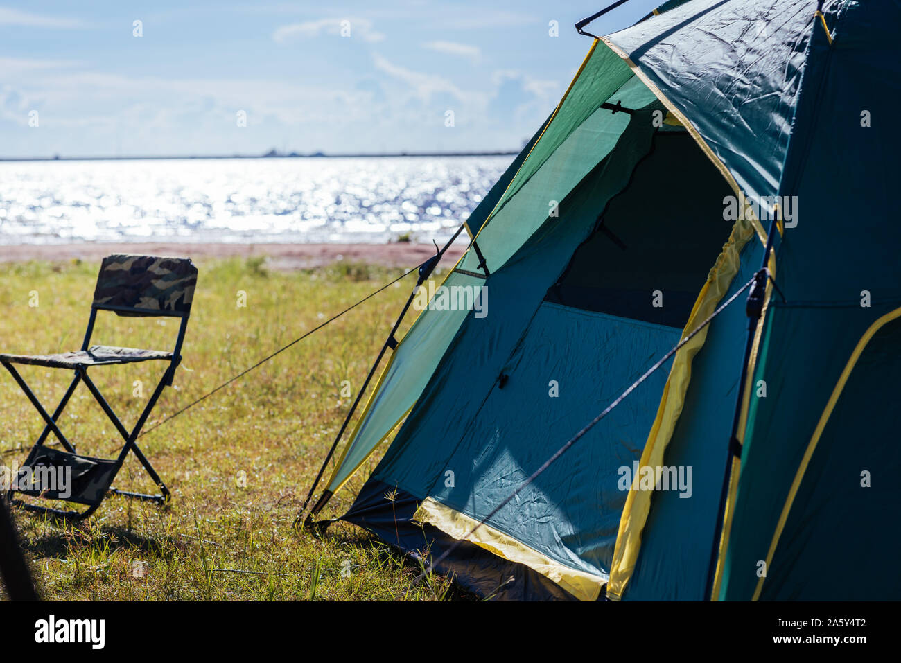 Camping green tent near lake, no people Stock Photo - Alamy