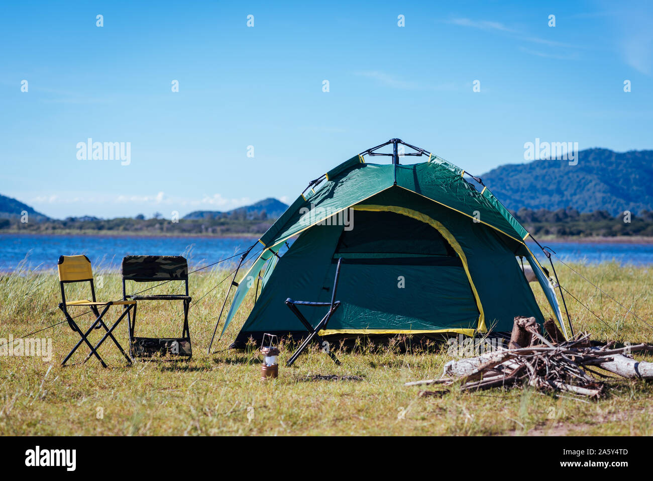 Camping green tent near lake, no people Stock Photo - Alamy