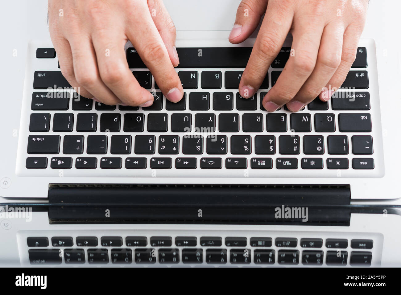 Hand typing on laptop keyboard picture from a high angle Stock Photo ...