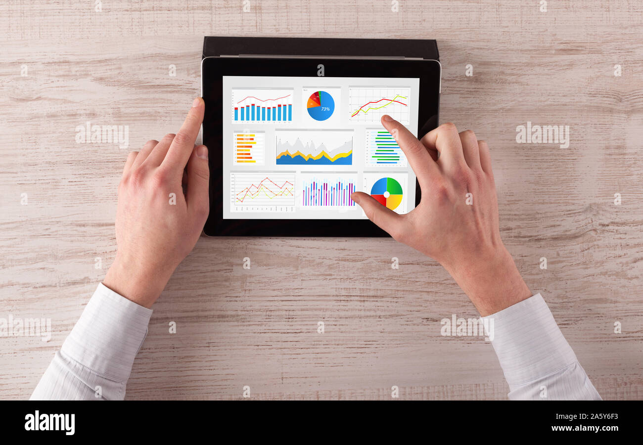 Hand making diagrams and charts on tablet Stock Photo - Alamy