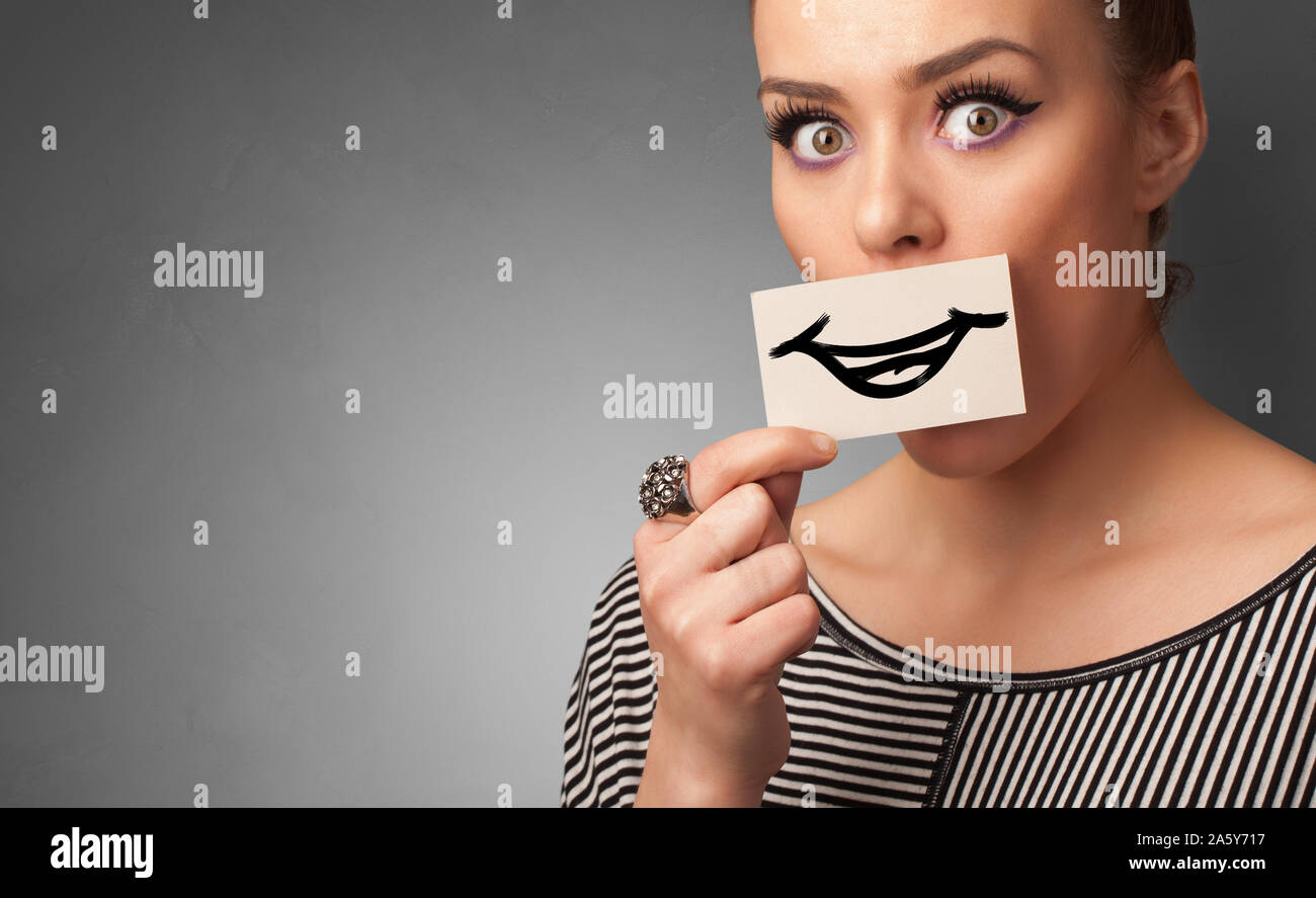 Person with smile card in front of his mouth Stock Photo - Alamy