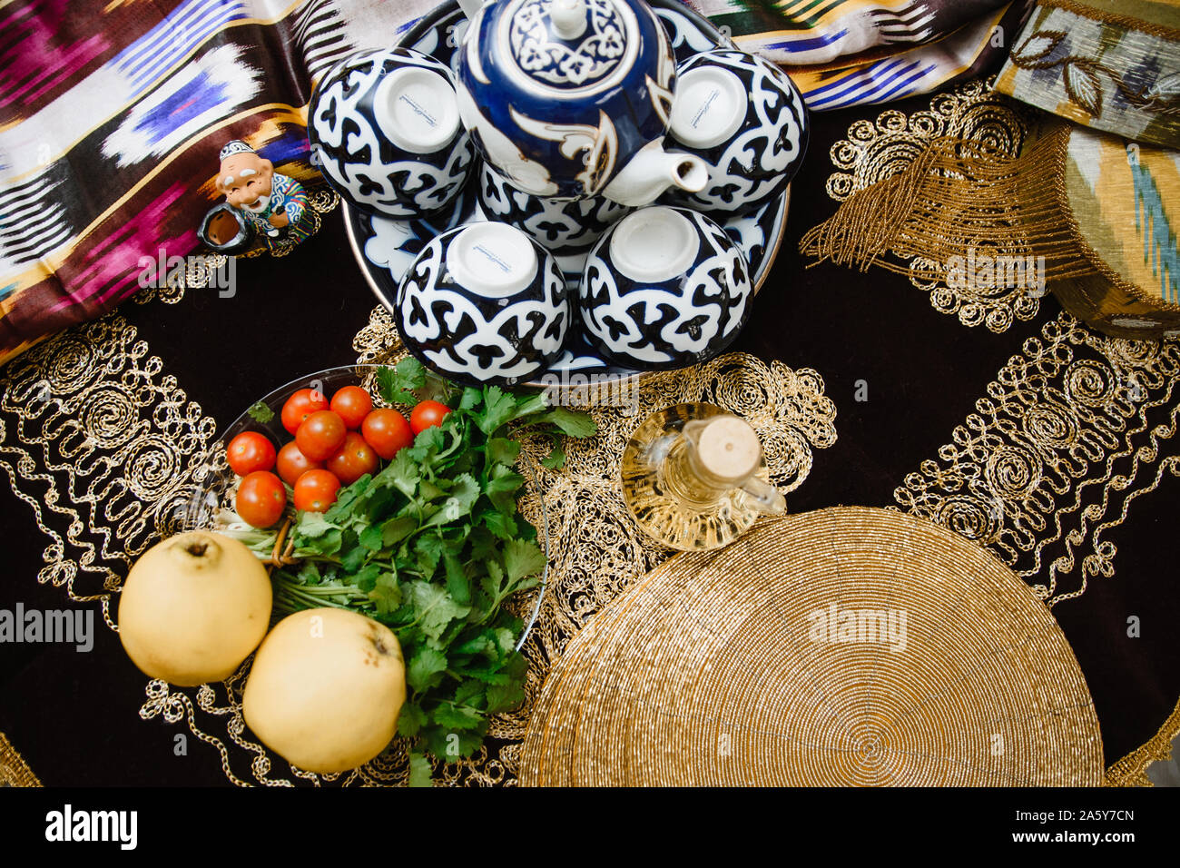 Quince fruits on a table decorated with oriental fabrics with ornaments ...