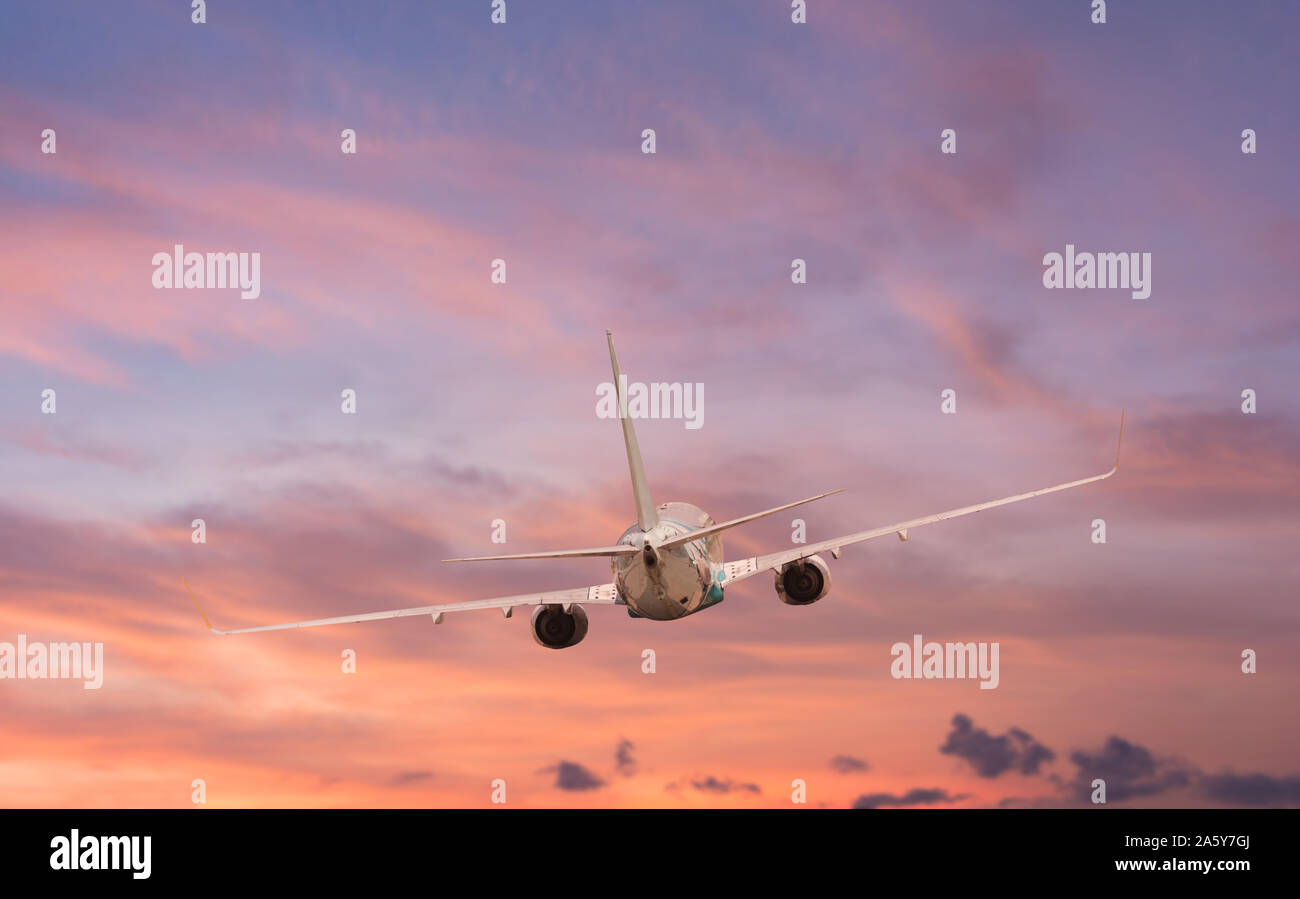 Airplane aft plane in the sky at sunset sky Stock Photo - Alamy
