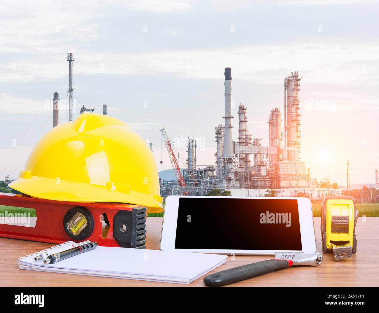 Working table engineer with tablet and tools in oil refinery industry ...