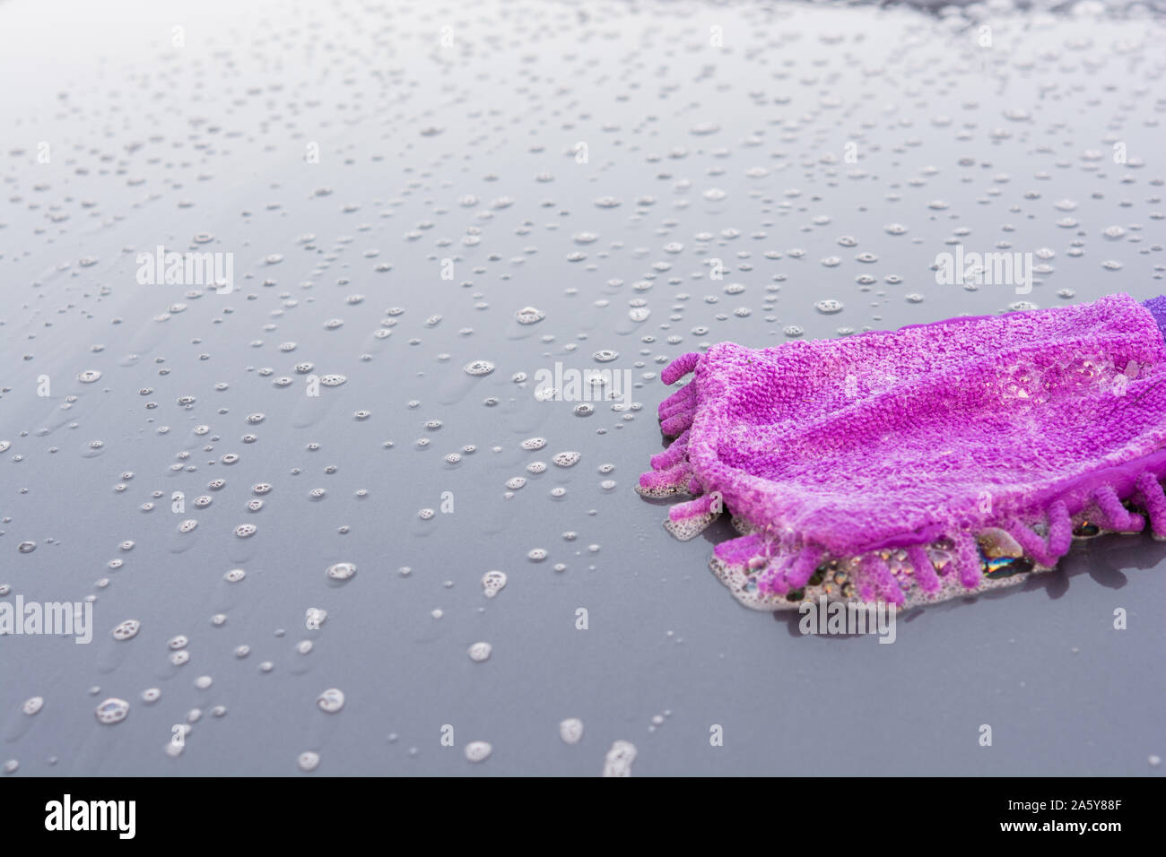 Closeup cleaning his car using gloves car wash gray color Stock Photo ...
